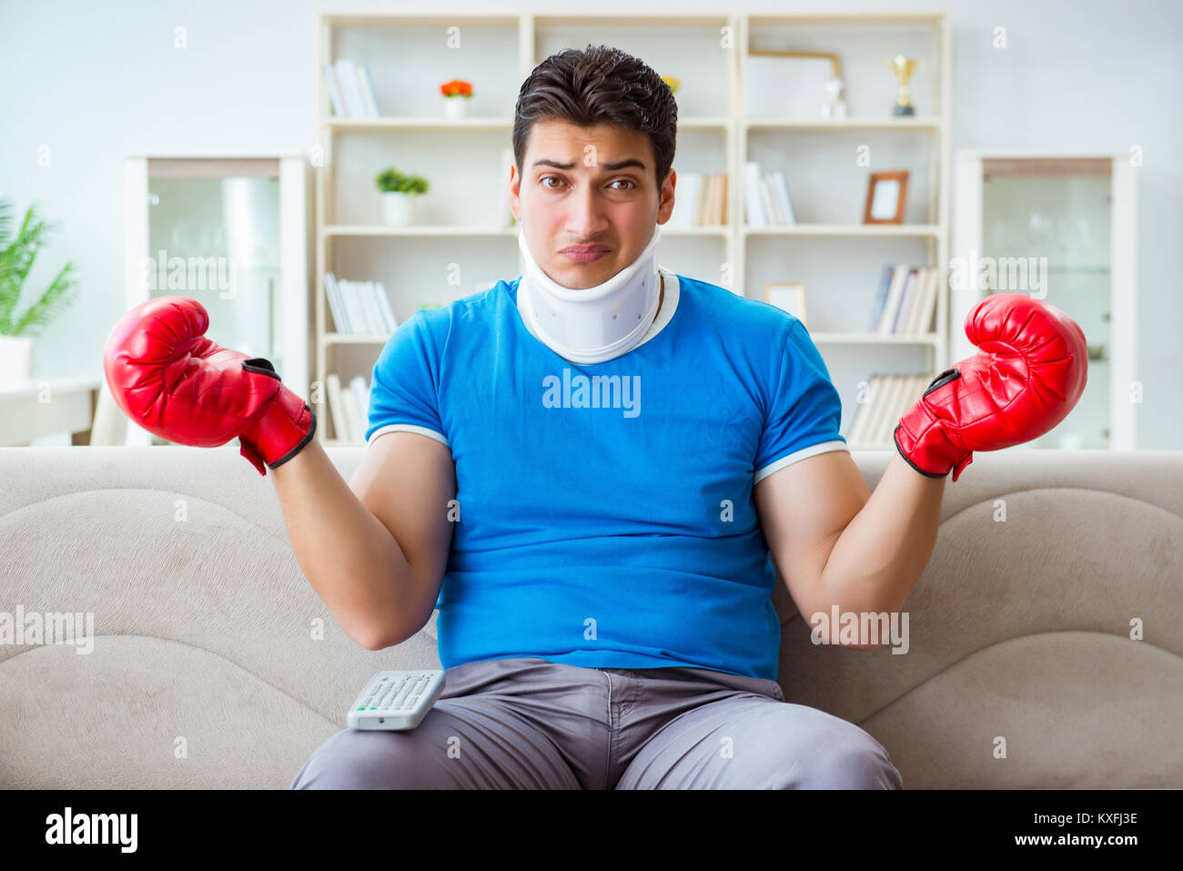 Man with neck injury watching boxing at home Stock Photo - Alamy