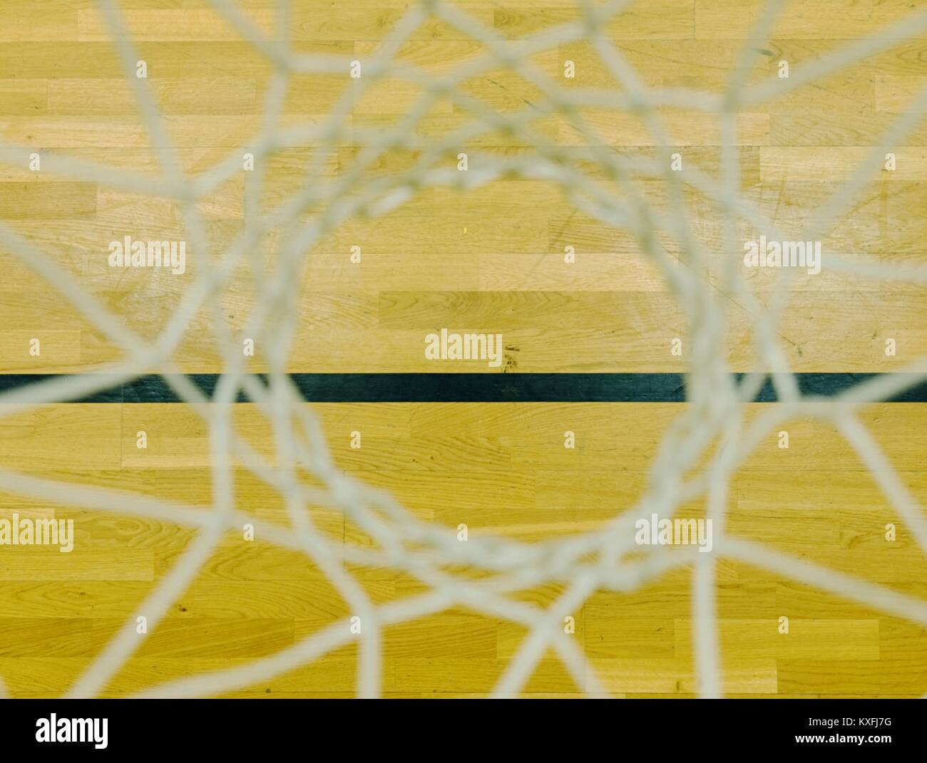 Look down through white string net, hardwood basketball board with ...