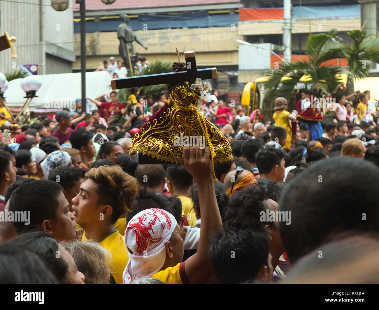 A miniature replica of black nazarene holding single handed by a ...
