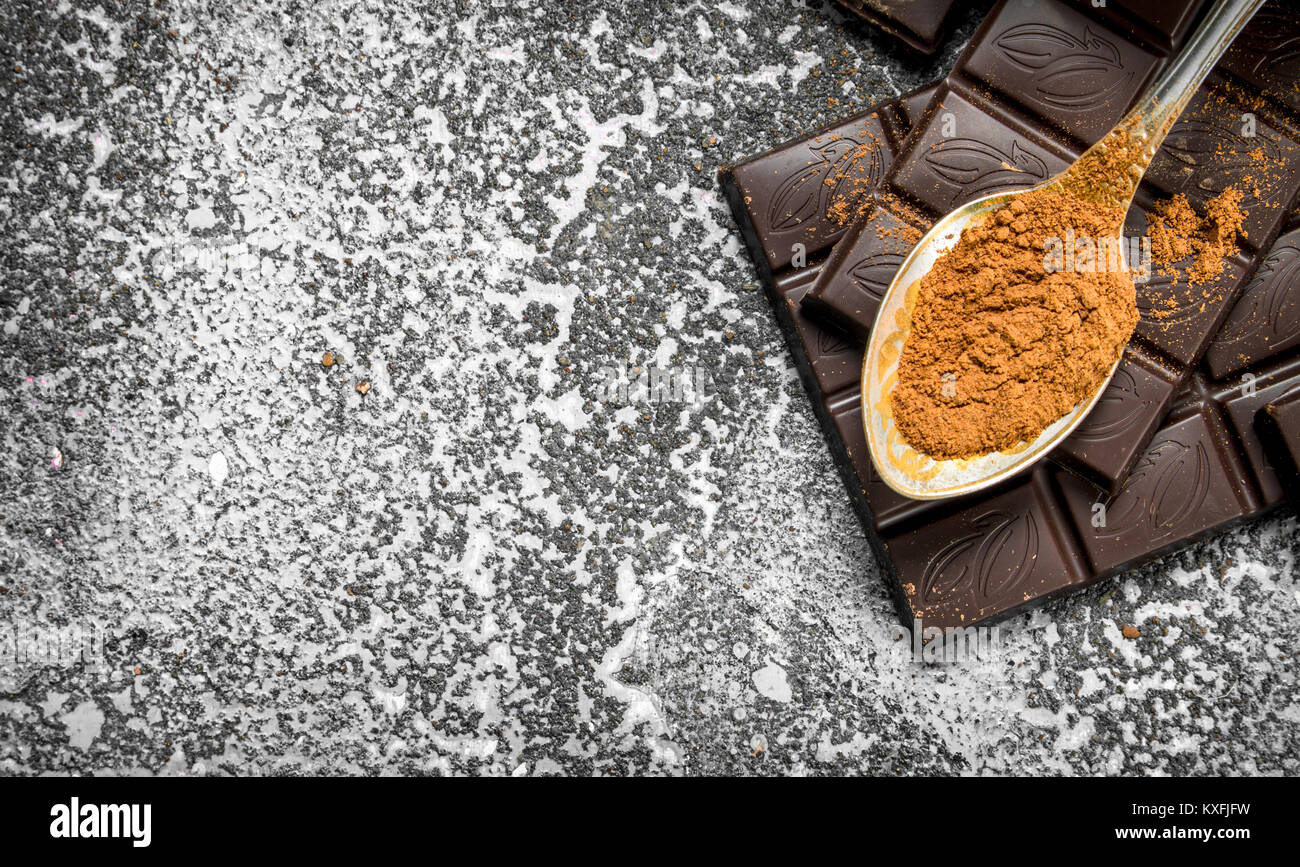 Dark chocolate with cocoa powder. On a rustic background Stock Photo ...
