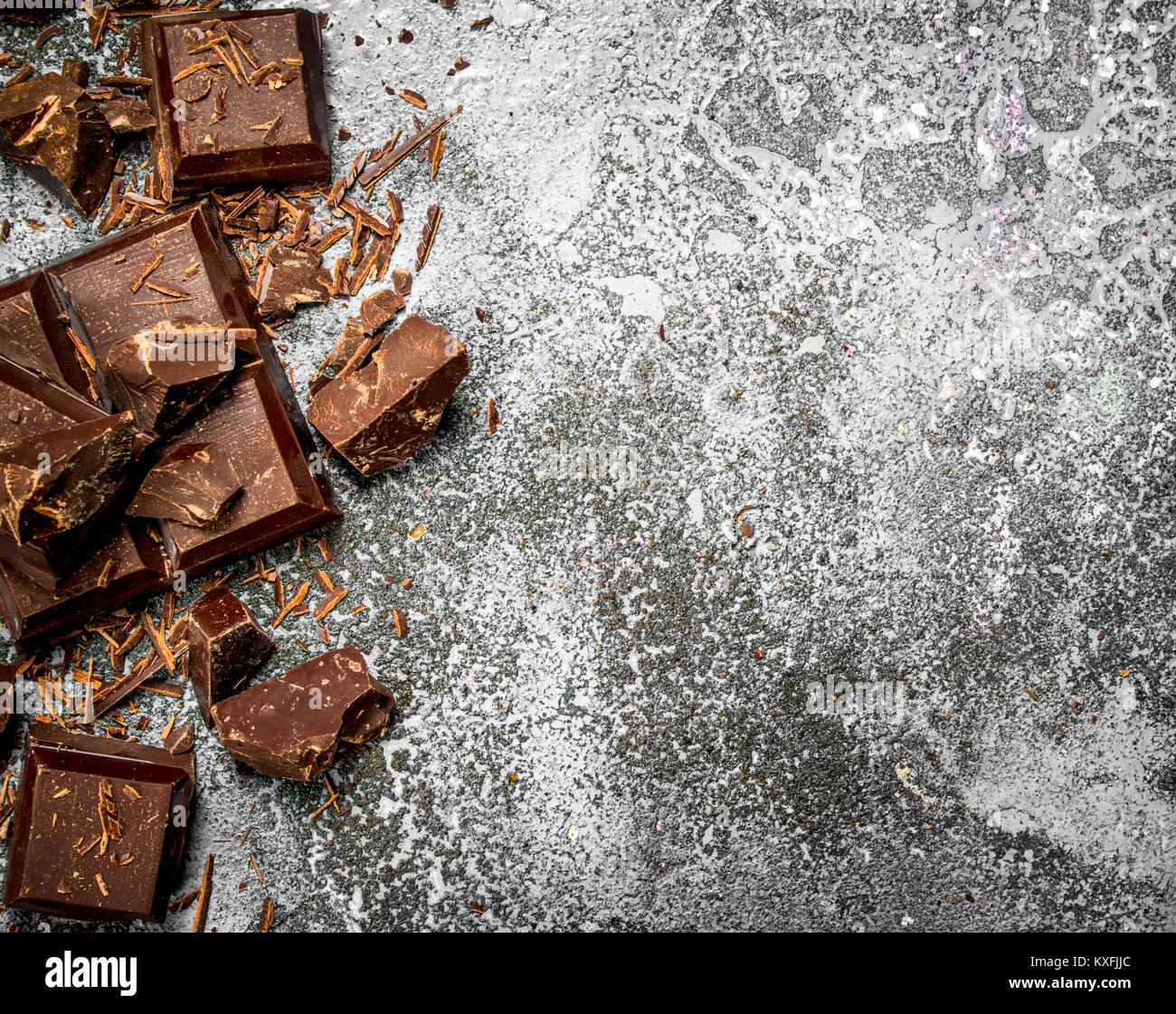 Pieces of dark chocolate. On a rustic background Stock Photo - Alamy