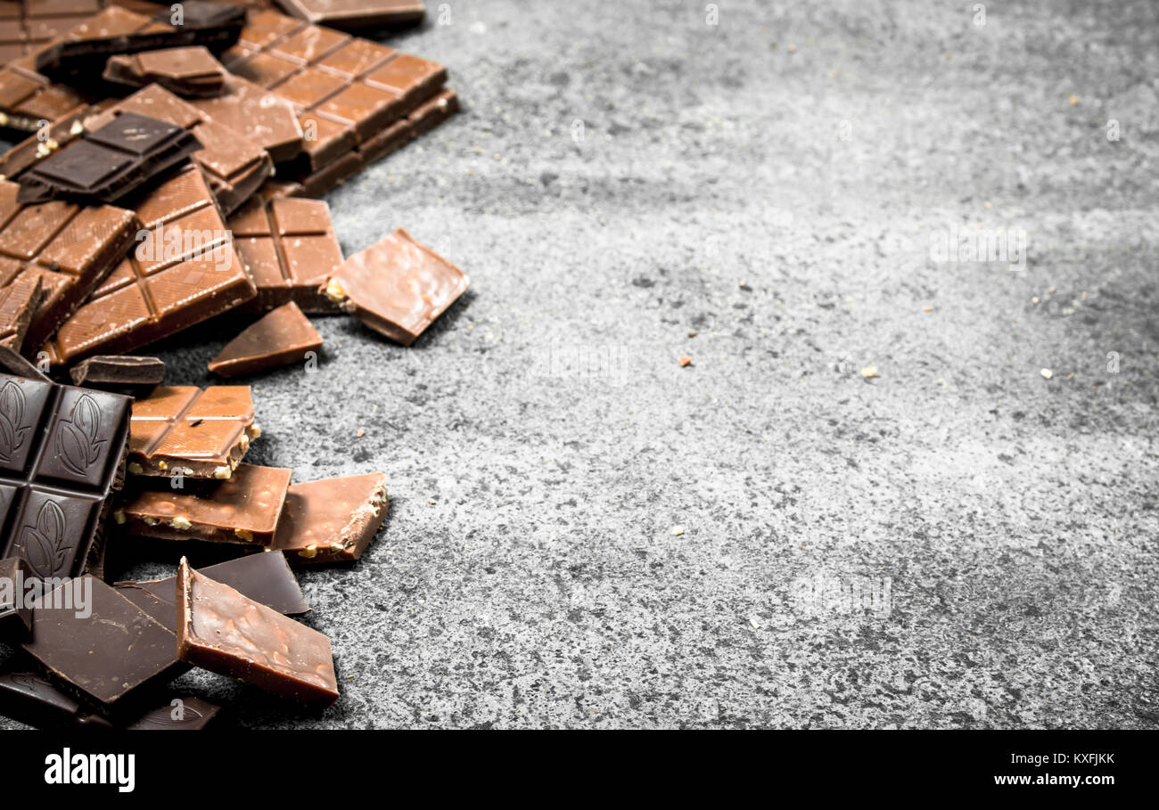 Broken chocolate bars. On a rustic background Stock Photo - Alamy