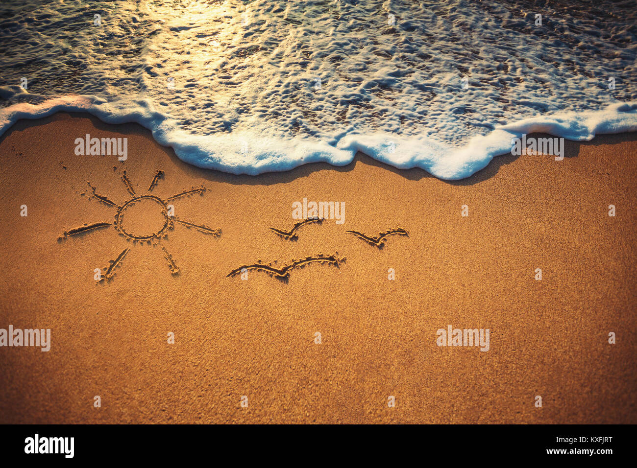 Closeup waves,sun and palm drawing on the sand beach near the ocean ...