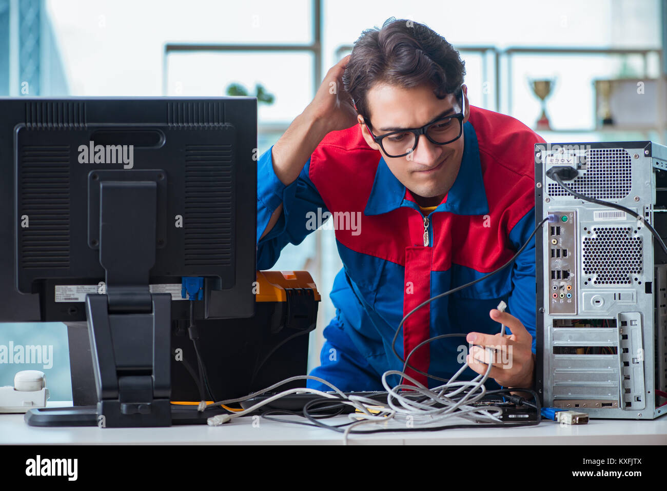 Computer repairman working on repairing computer in IT workshop Stock ...
