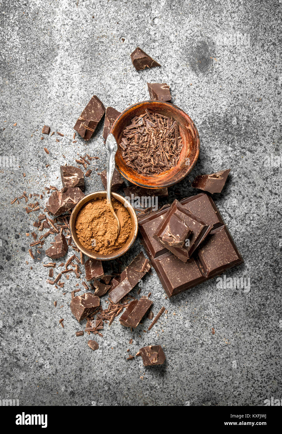 Chunks of chocolate with cocoa powder. On a rustic background Stock ...