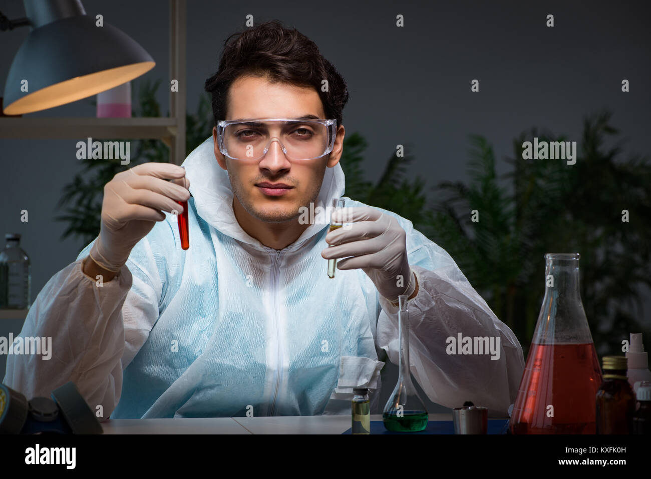 Young male doctor doing blood test late at night in overtime time Stock ...