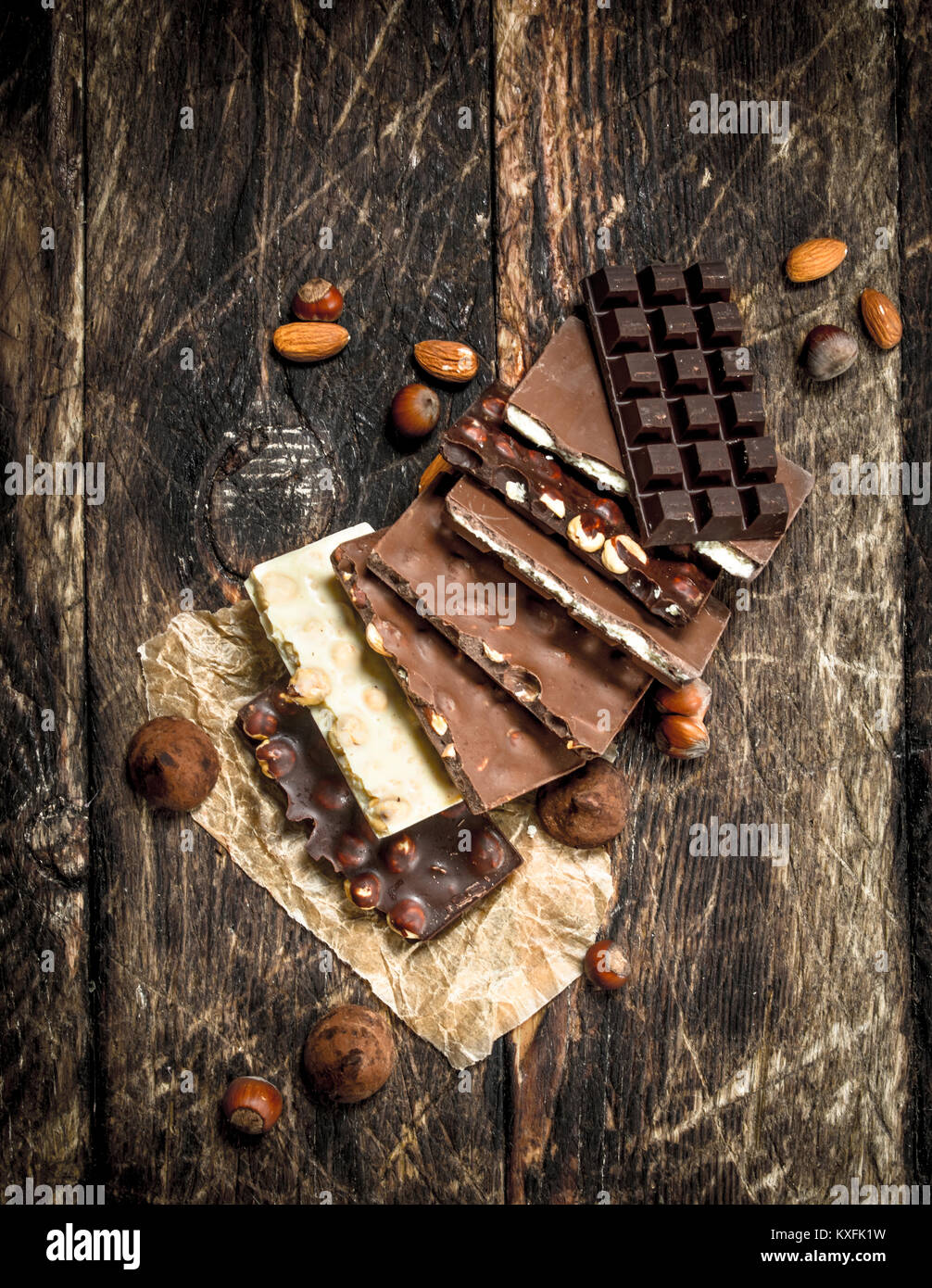 Different types of chocolate. On a wooden background Stock Photo - Alamy
