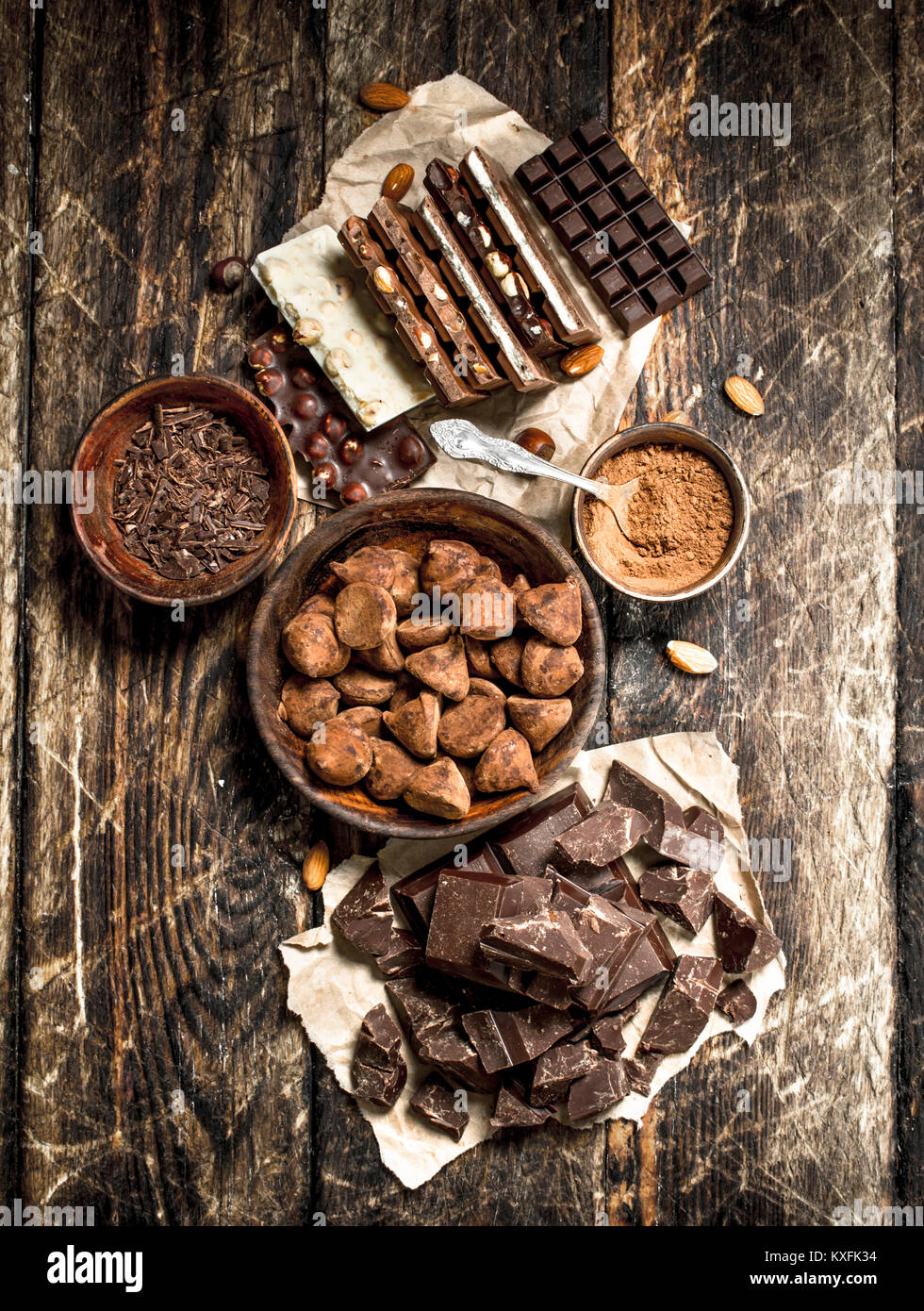 Different types of chocolate, cocoa powder and pieces of dark chocolate ...