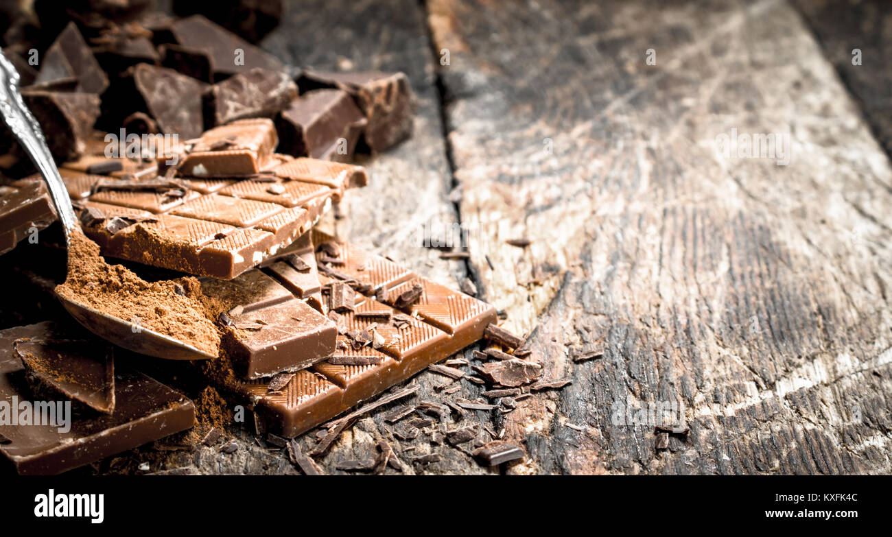 Chocolate bars with cocoa powder. On a wooden background Stock Photo ...
