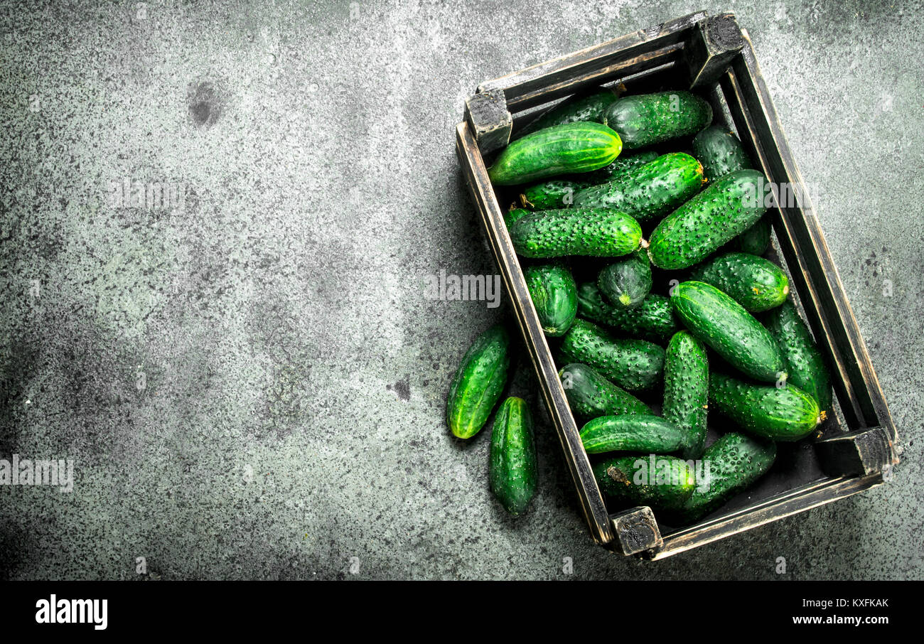 Fresh cucumbers in an old box. on a rustic background Stock Photo - Alamy