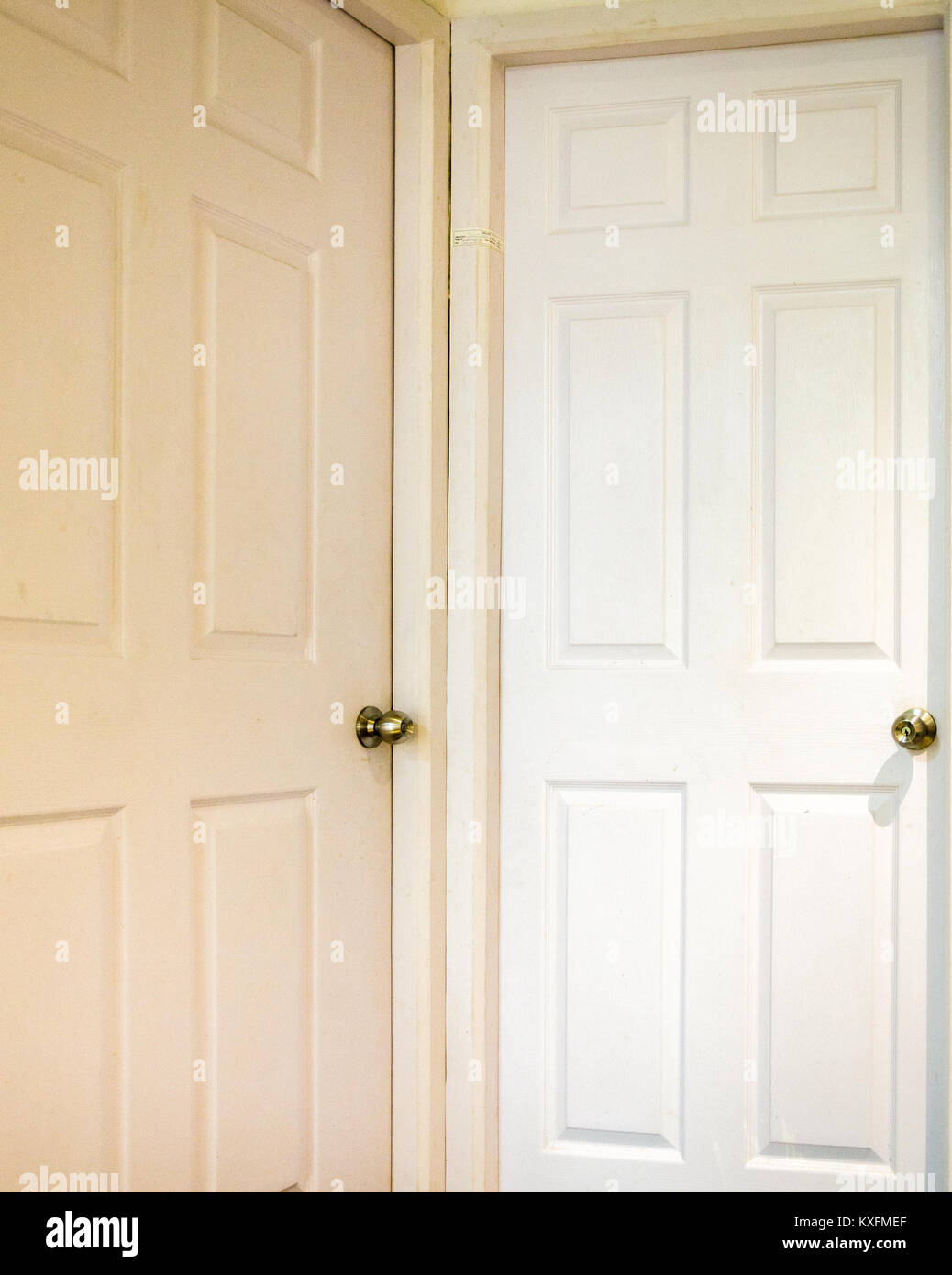 Two white doors side by side forming a corner Stock Photo - Alamy