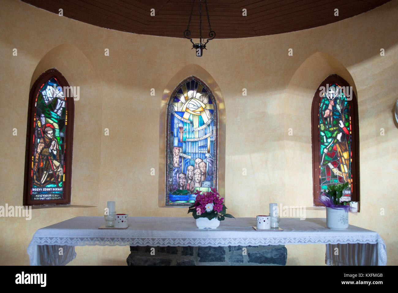 Altar and stained glass windows in the Galyatető Roman Catholic church ...