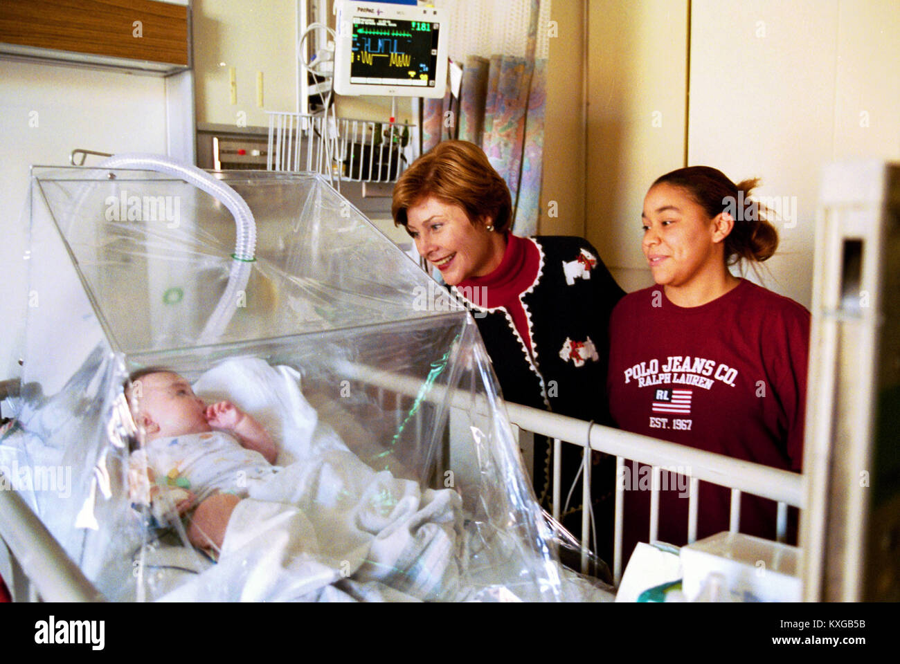 First lady Laura Bush visits with 4-month-old Devon Garner and his ...