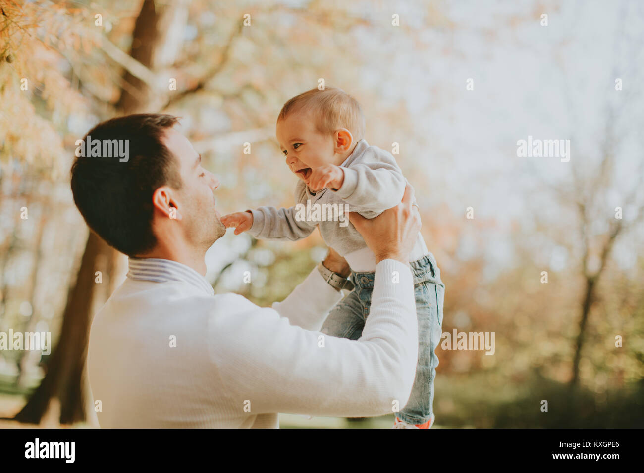 Young father and baby boy playing in autumn park at sunny day Stock ...