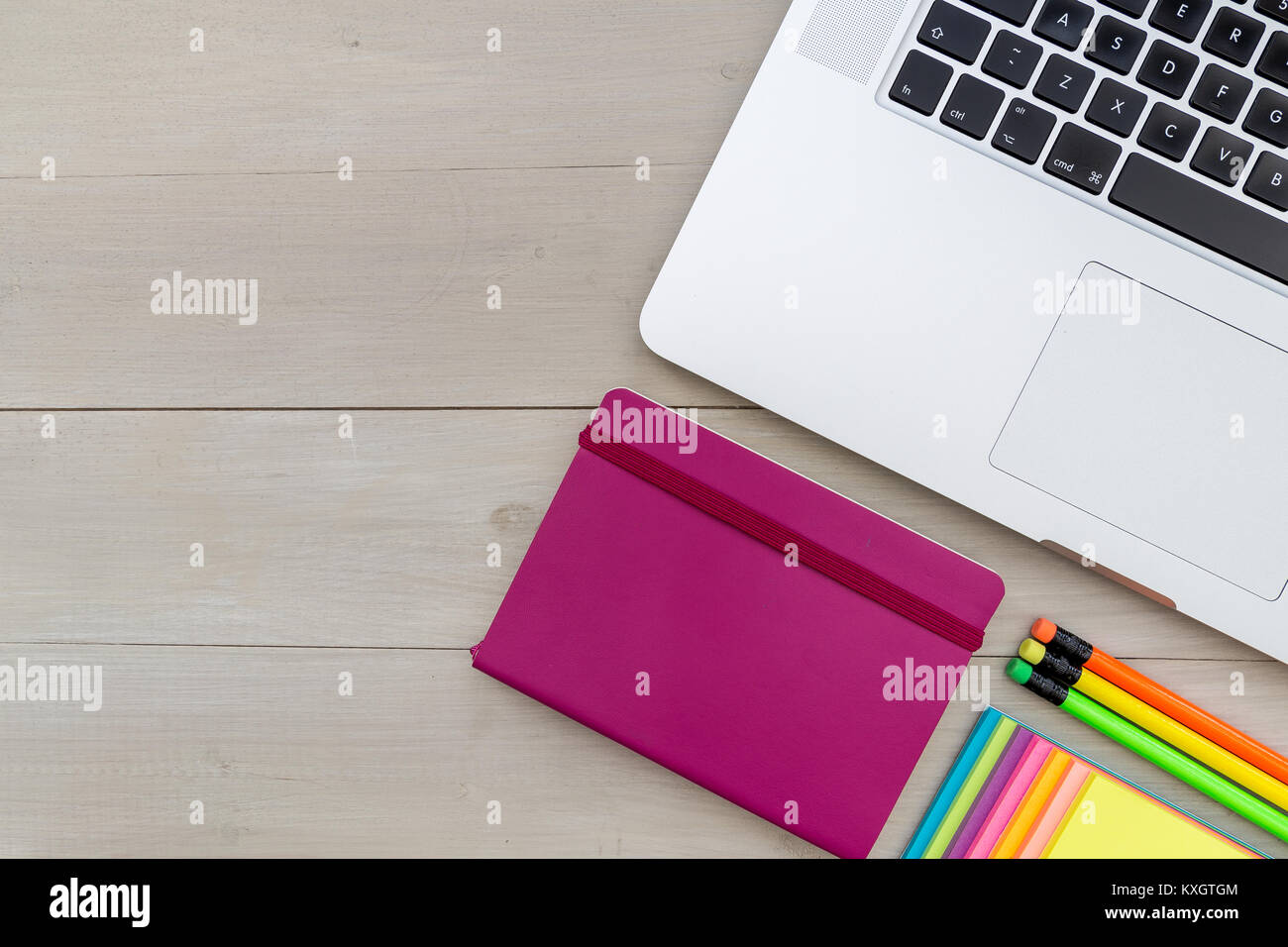 Laptop computer with notebook and pencils on wood office desk Stock ...