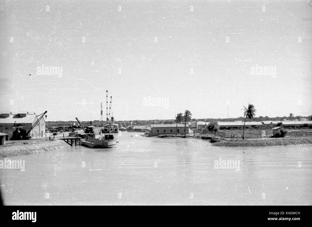 The image depicts Abadan Harbor with a British ship, highlighting maritime activity and the port ...