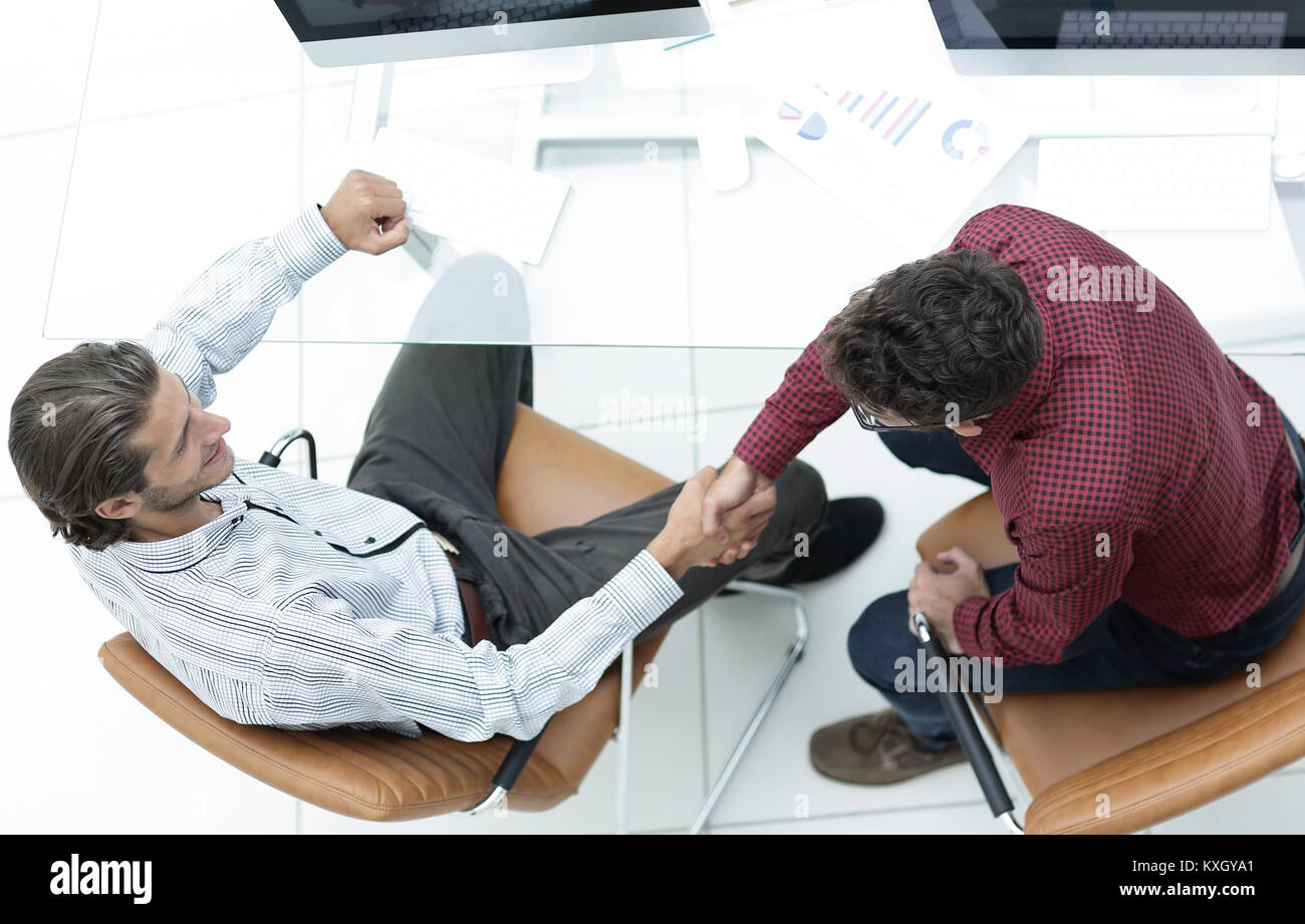 handshake of the staff over a Desk Stock Photo - Alamy