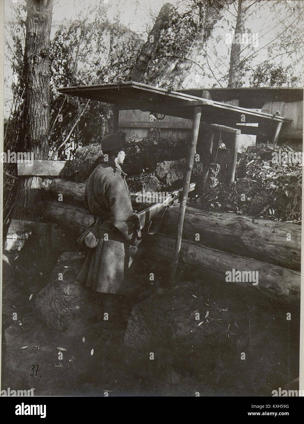 This image depicts a scene of a military alarm post in a trench, likely ...