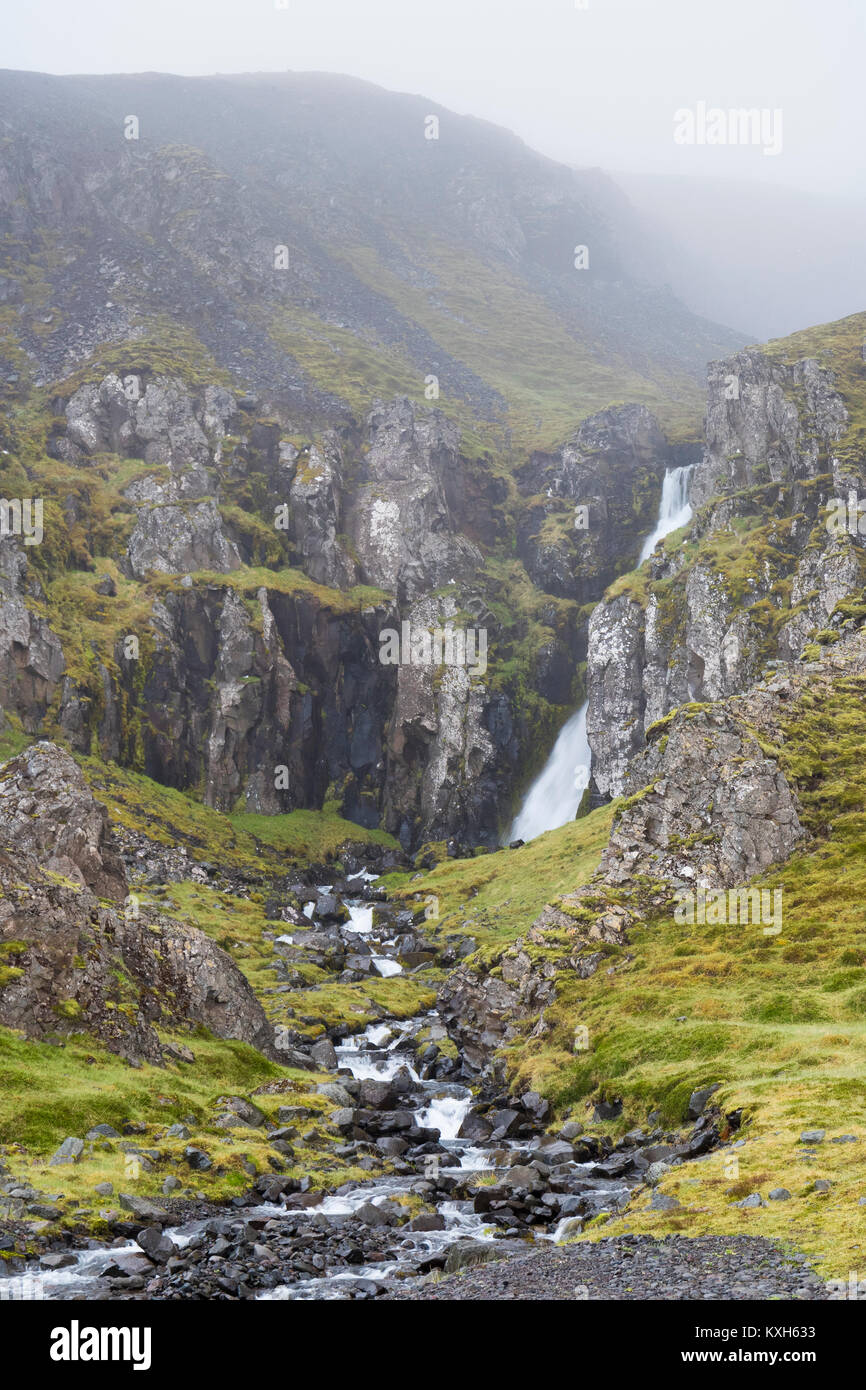 Waterfall, water flowing among steep rocks in Iceland Stock Photo - Alamy