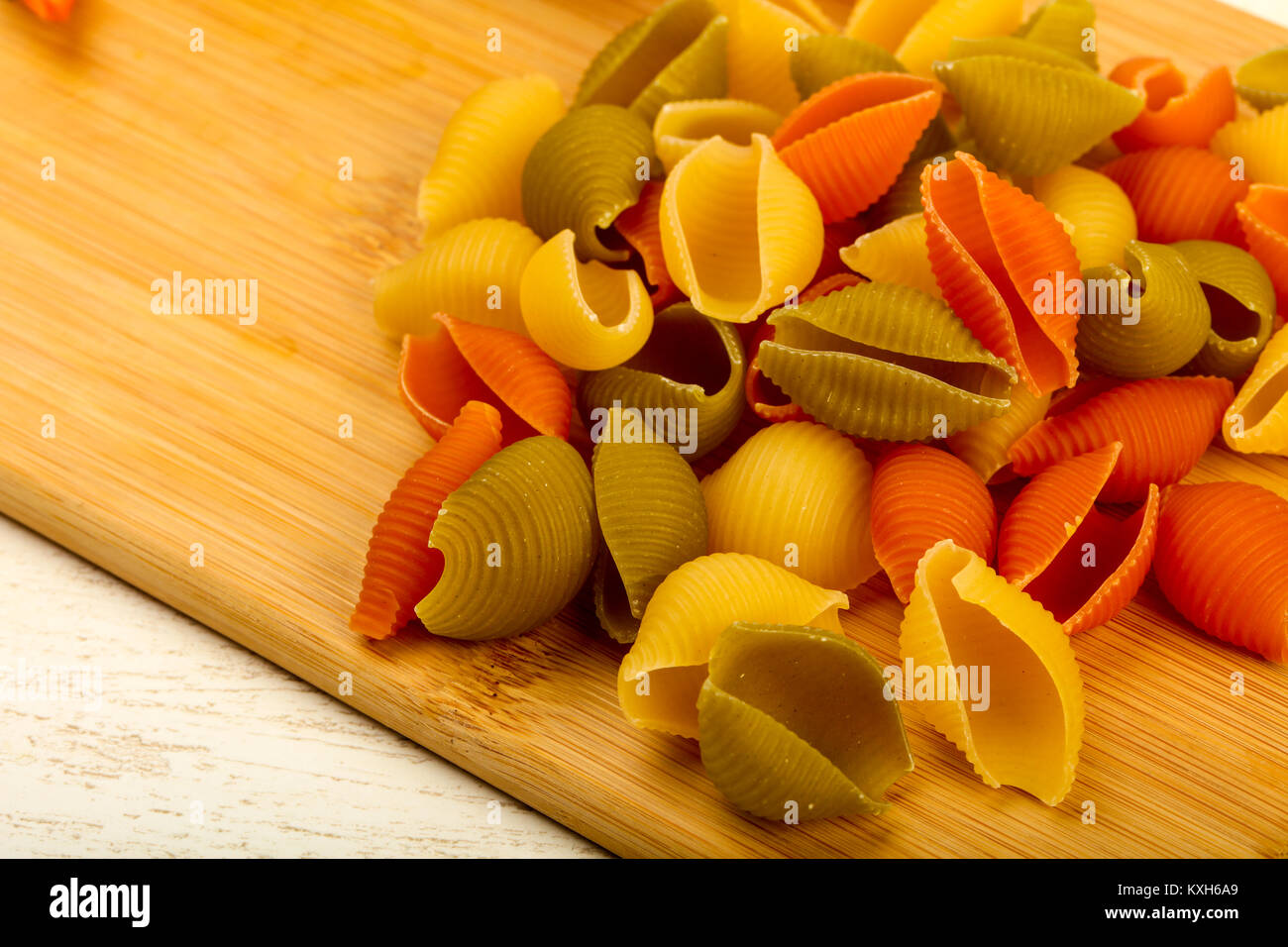 Raw pasta ready for cooking over the wooden background Stock Photo - Alamy
