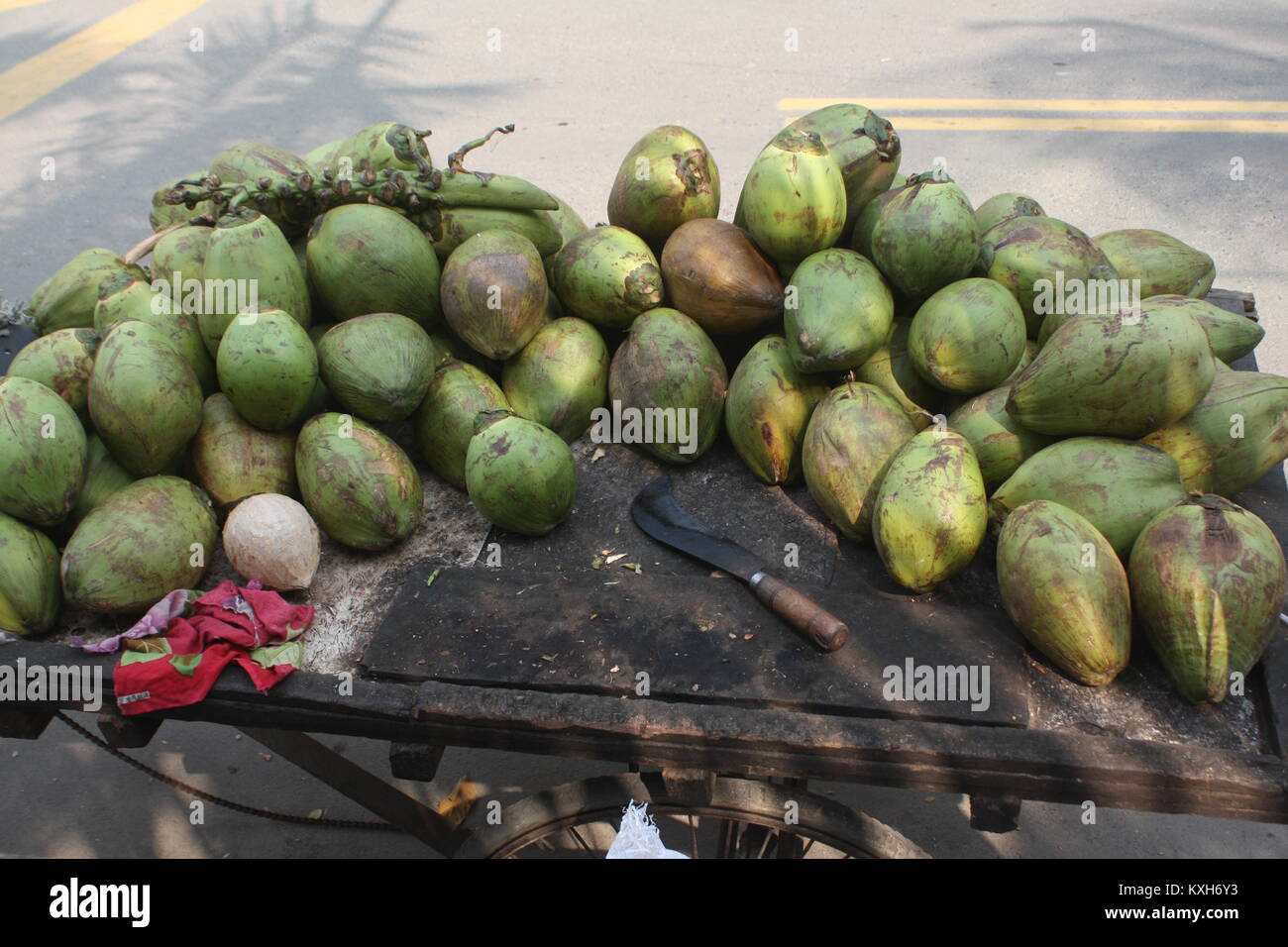 Fresh Coconut seller in market. Coconut water is a popular drink in the ...