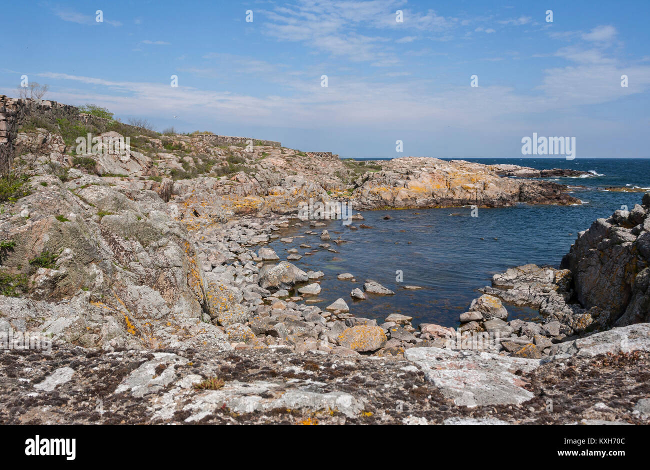 Rocks on the coast and the ring wall surrounding Christiansø ...