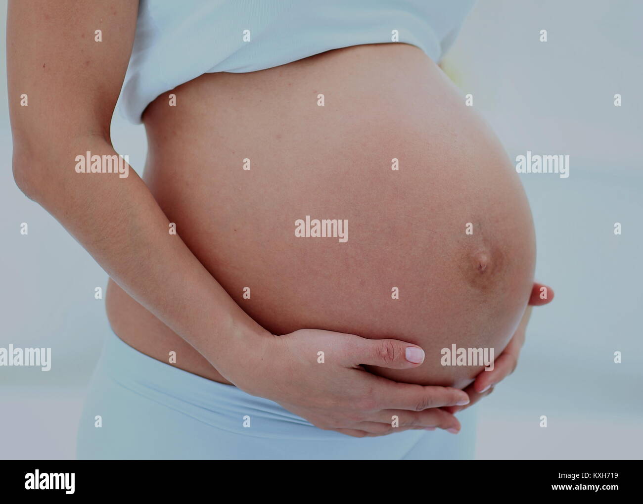 woman holds her baby bump Stock Photo - Alamy