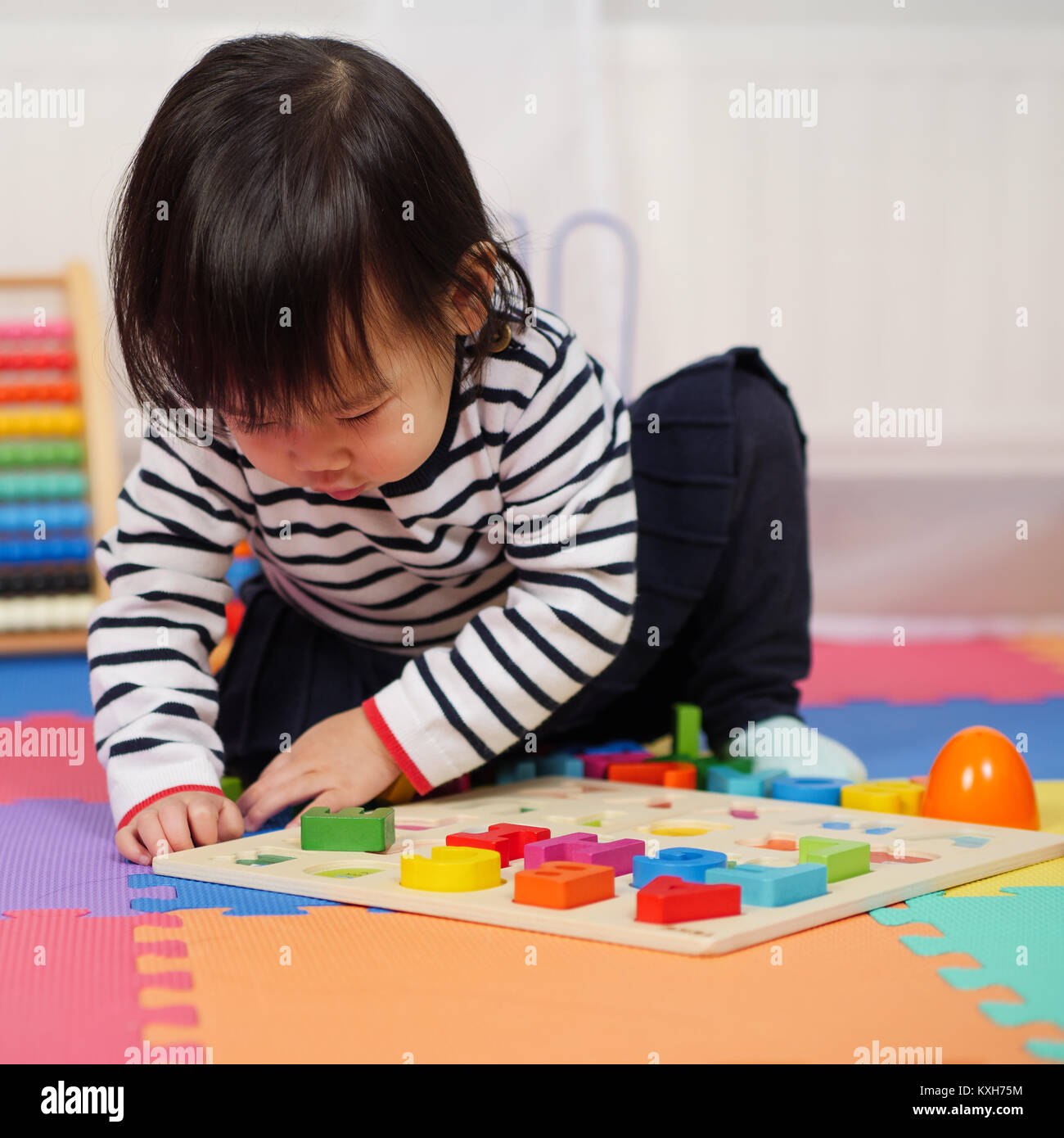 baby girl learning alphabet at home Stock Photo - Alamy