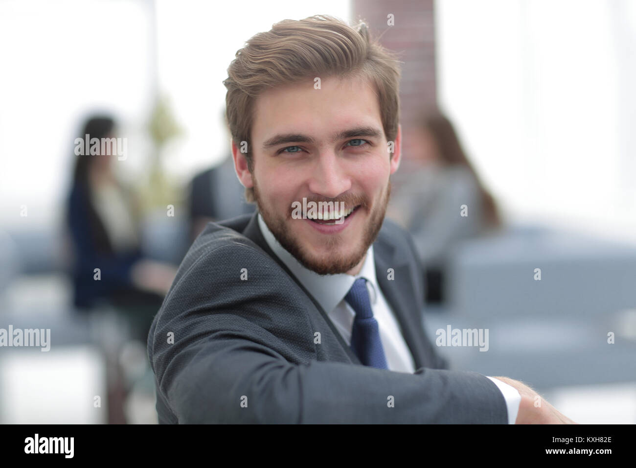 Successful business man standing with his staff in background at Stock ...