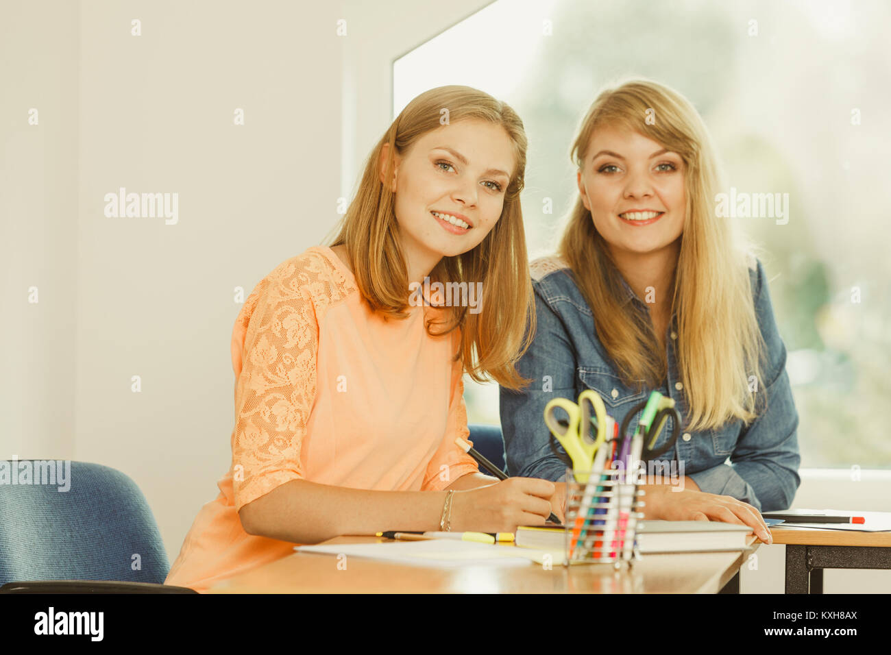 Two students sitting in class planning concept, studying together ...