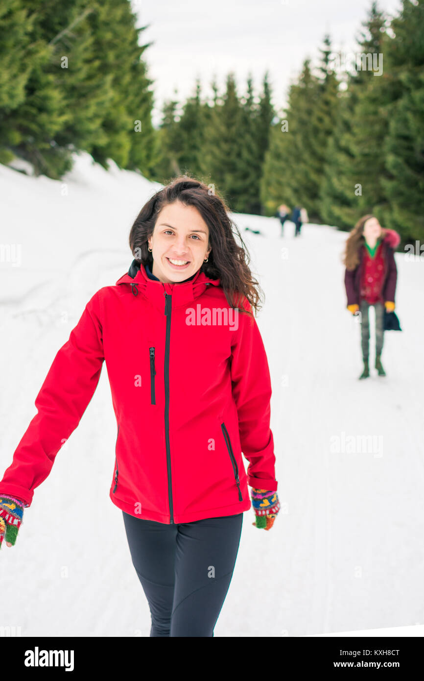 Happy girls on a hiking trip on snowy mountain path Stock Photo - Alamy