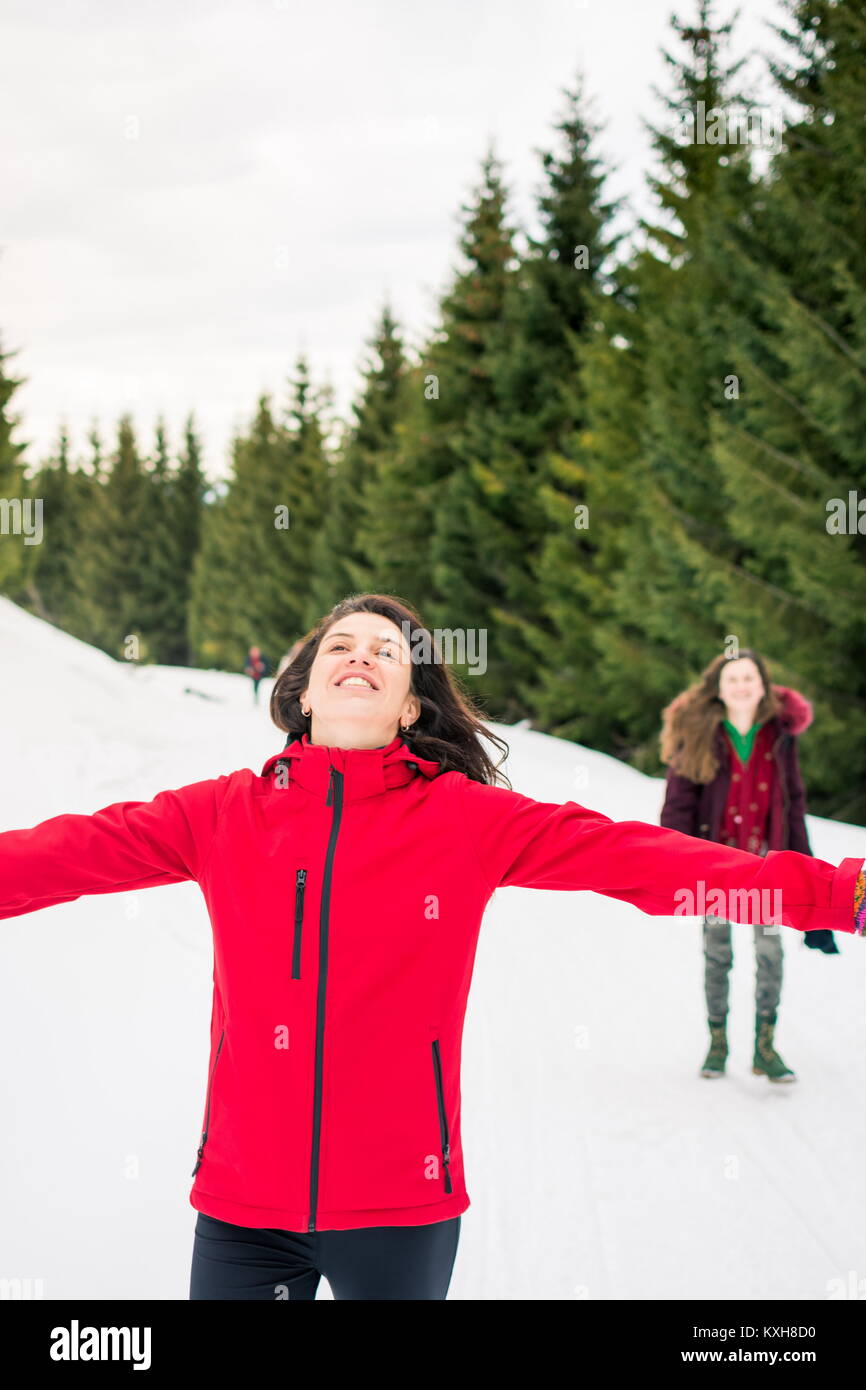 Happy girls on a hiking trip on snowy mountain path Stock Photo - Alamy