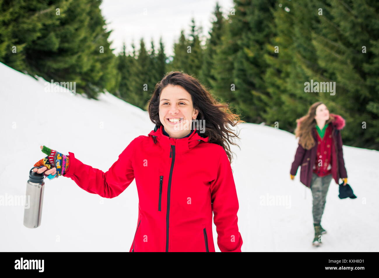 Happy girls on a hiking trip on snowy mountain path Stock Photo - Alamy
