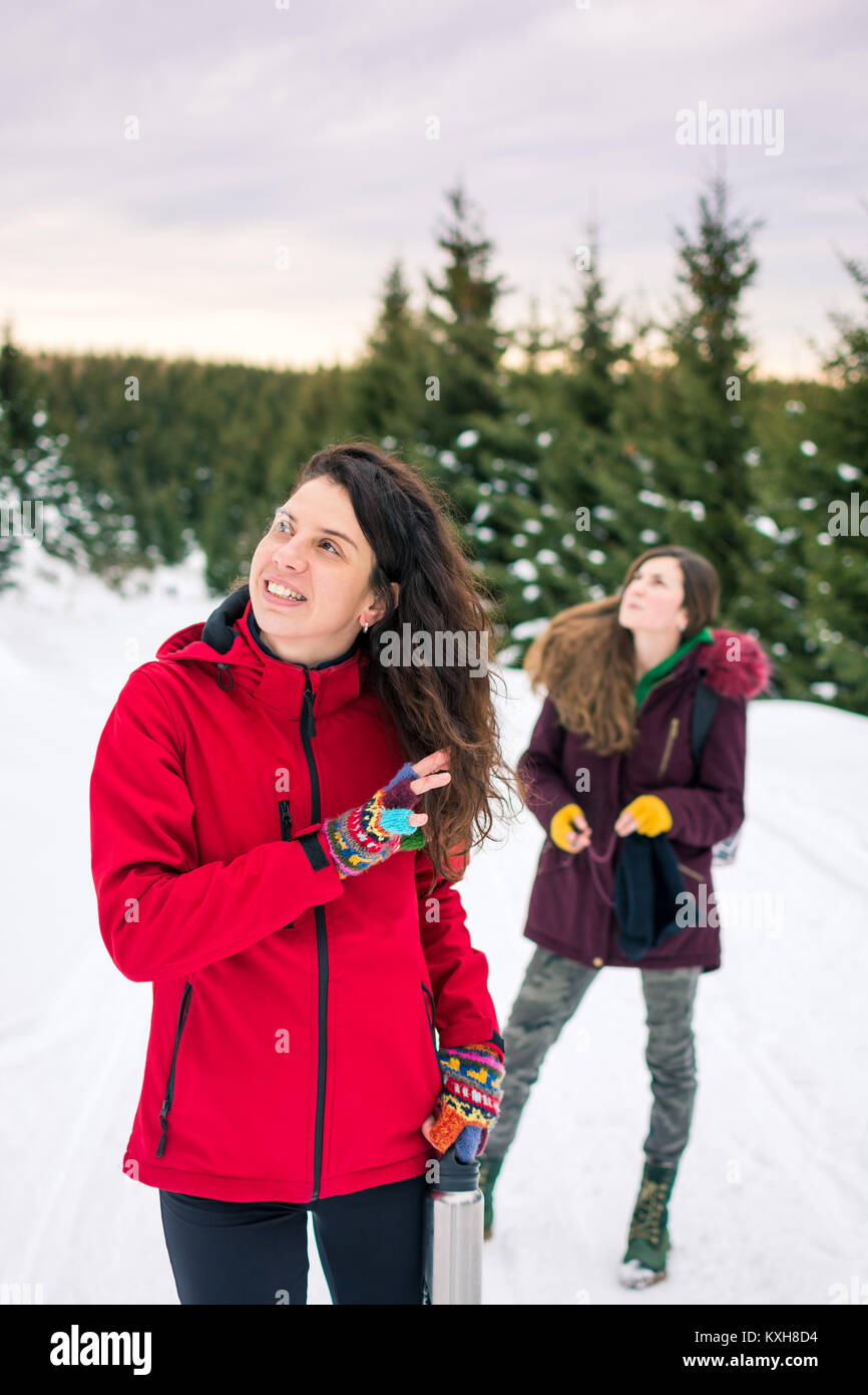Happy girls on a hiking trip on snowy mountain path Stock Photo - Alamy