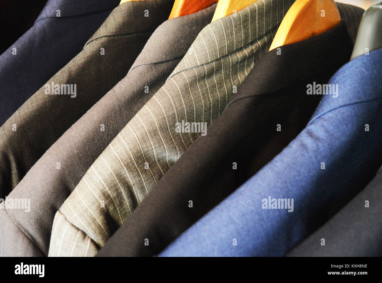 Men's suits hanging on a rail Stock Photo - Alamy
