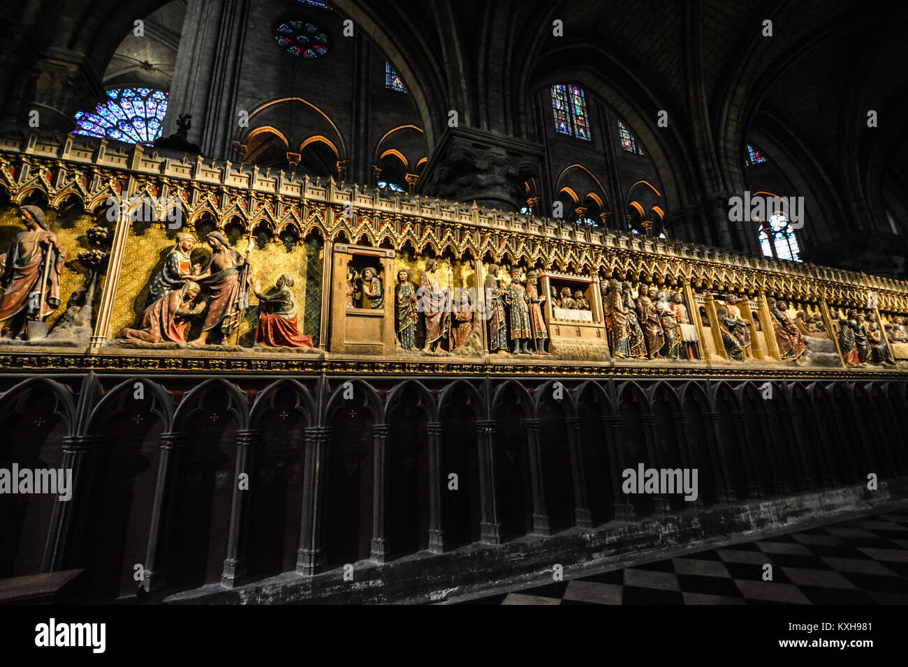 The dark, gothic interior of the Notre Dame Cathedral in Paris France ...