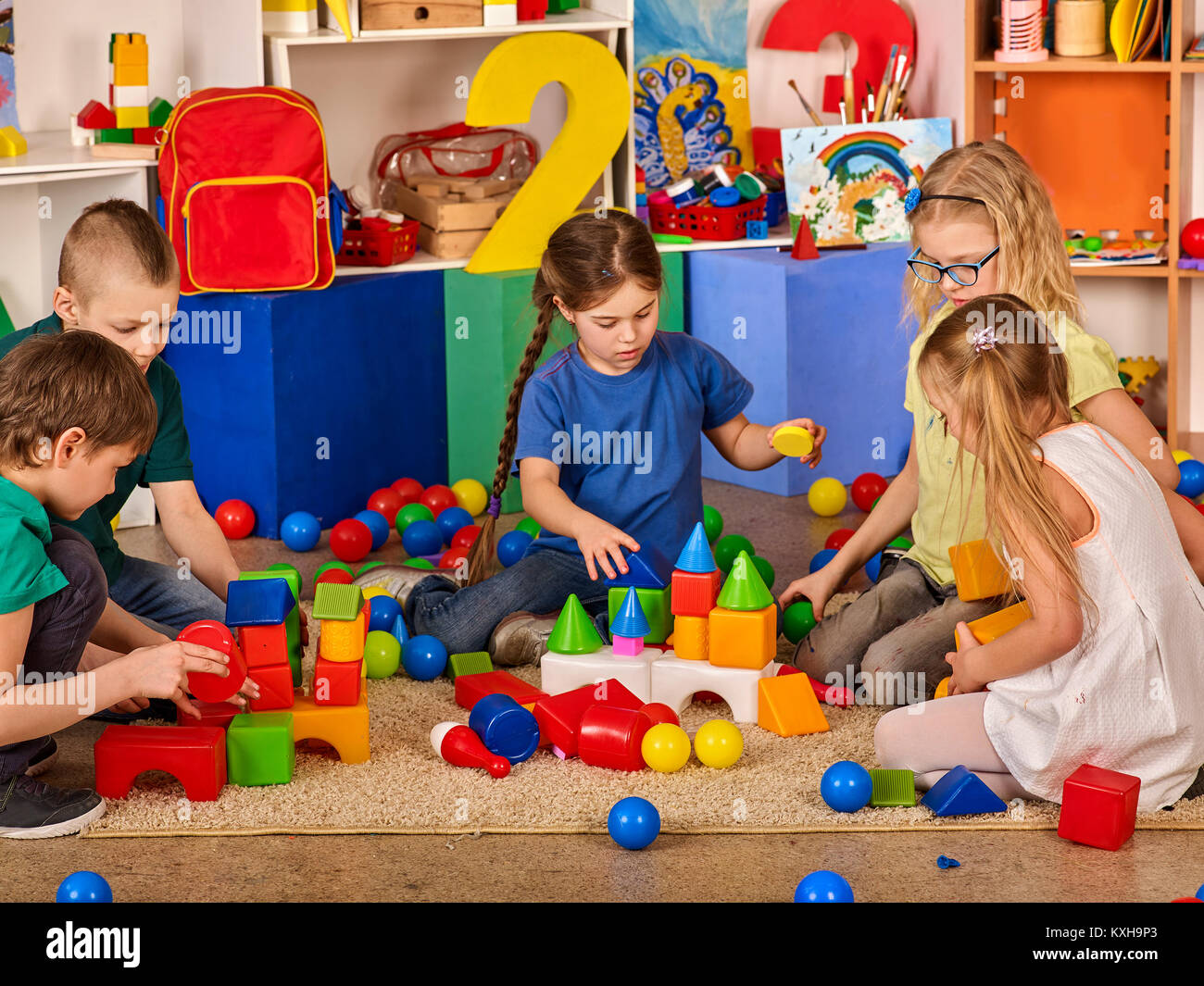 Children building blocks in kindergarten. Group kids playing toy floor ...