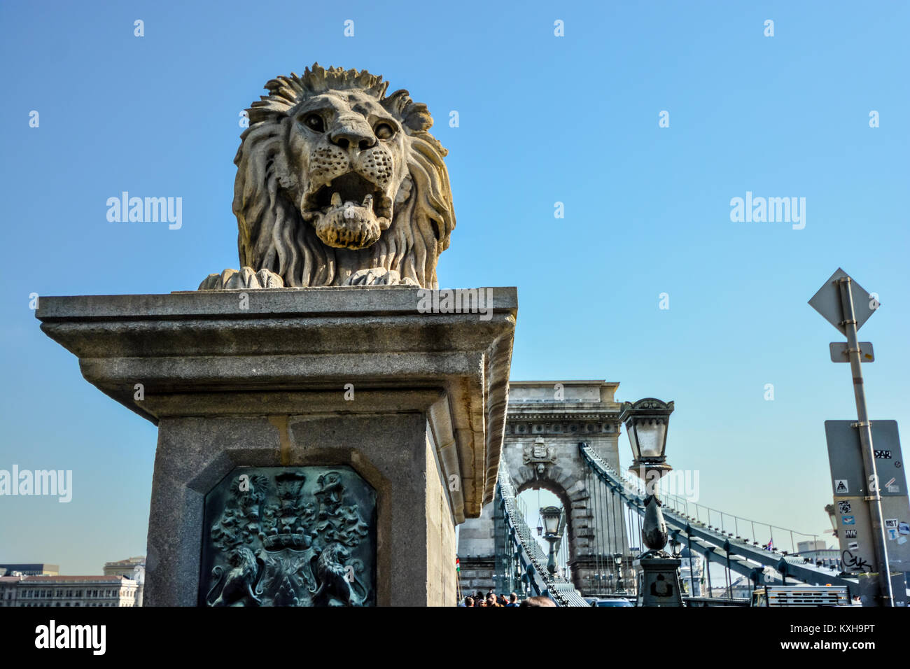 One of the stone lions carved by János Marschalkó on the Chain Bridge ...