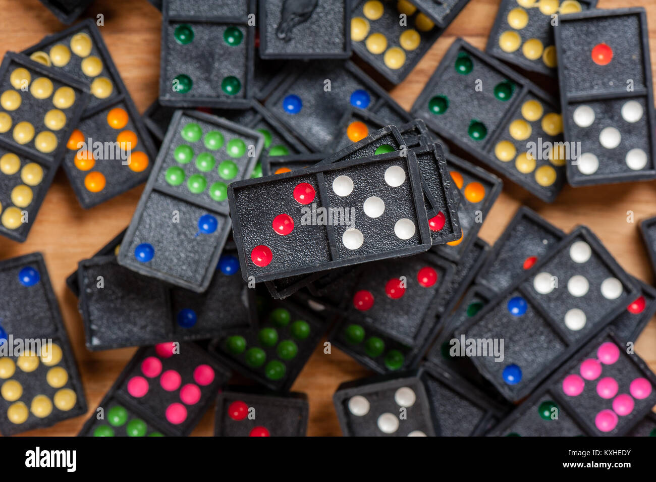 Dominoes on wooden table. Dominoes is a game played with rectangular ...
