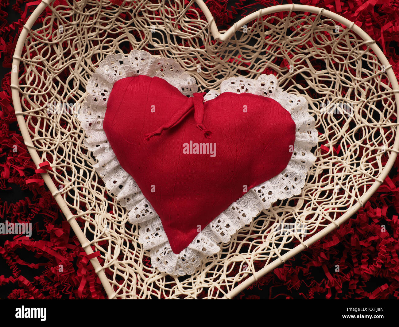 Red fabric heart shape on red shredded paper, love concepts Valentines ...