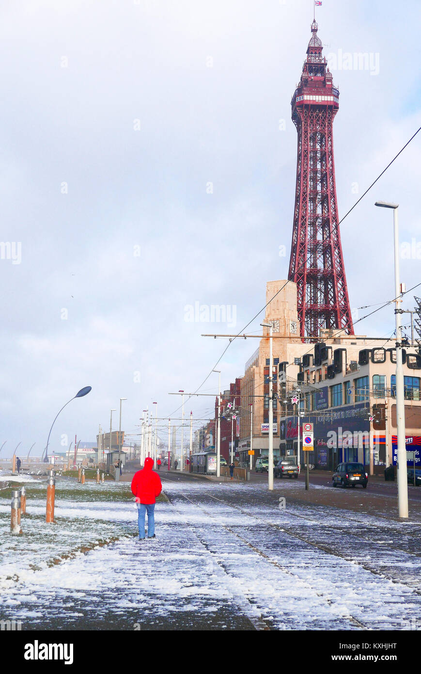 Man in red coat walking along Blackpool seafront during storm Stock ...