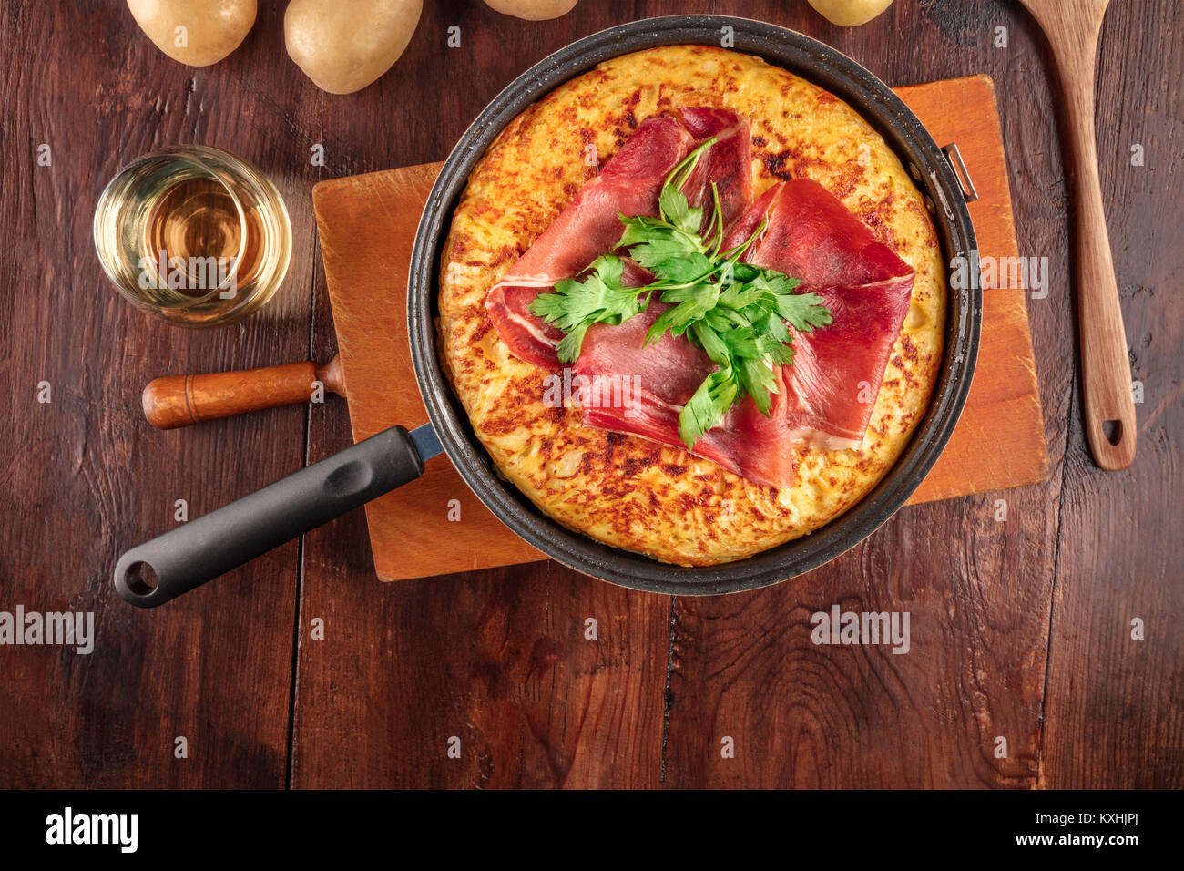 An overhead photo of a Spanish tortilla in a traditional tortillera ...