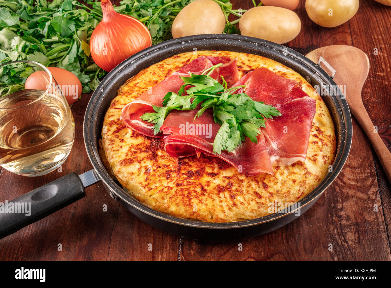 A closeup photo of a Spanish tortilla in a traditional tortillera, with ...