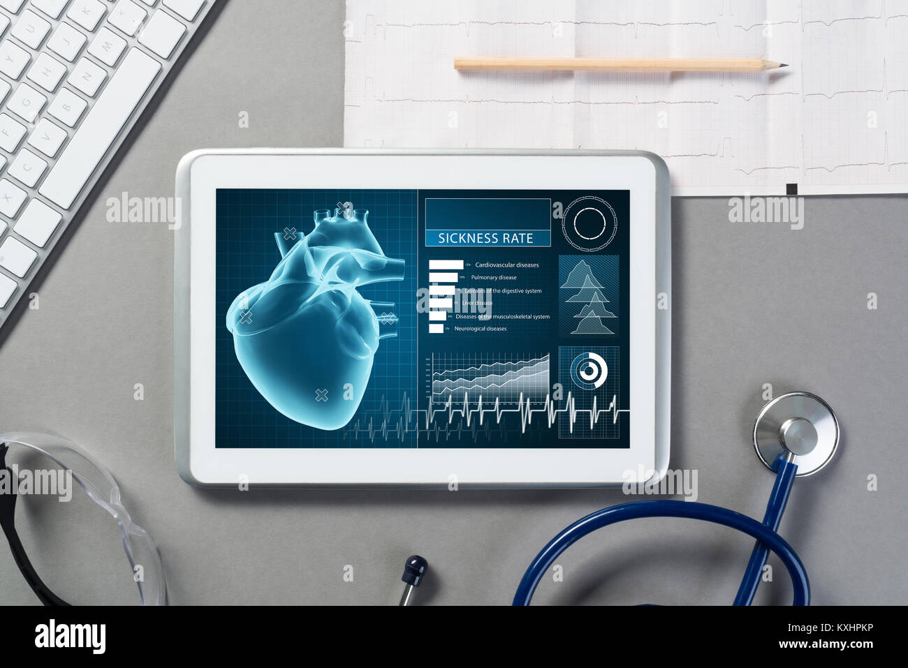 White tablet pc and doctor tools on gray surface Stock Photo - Alamy