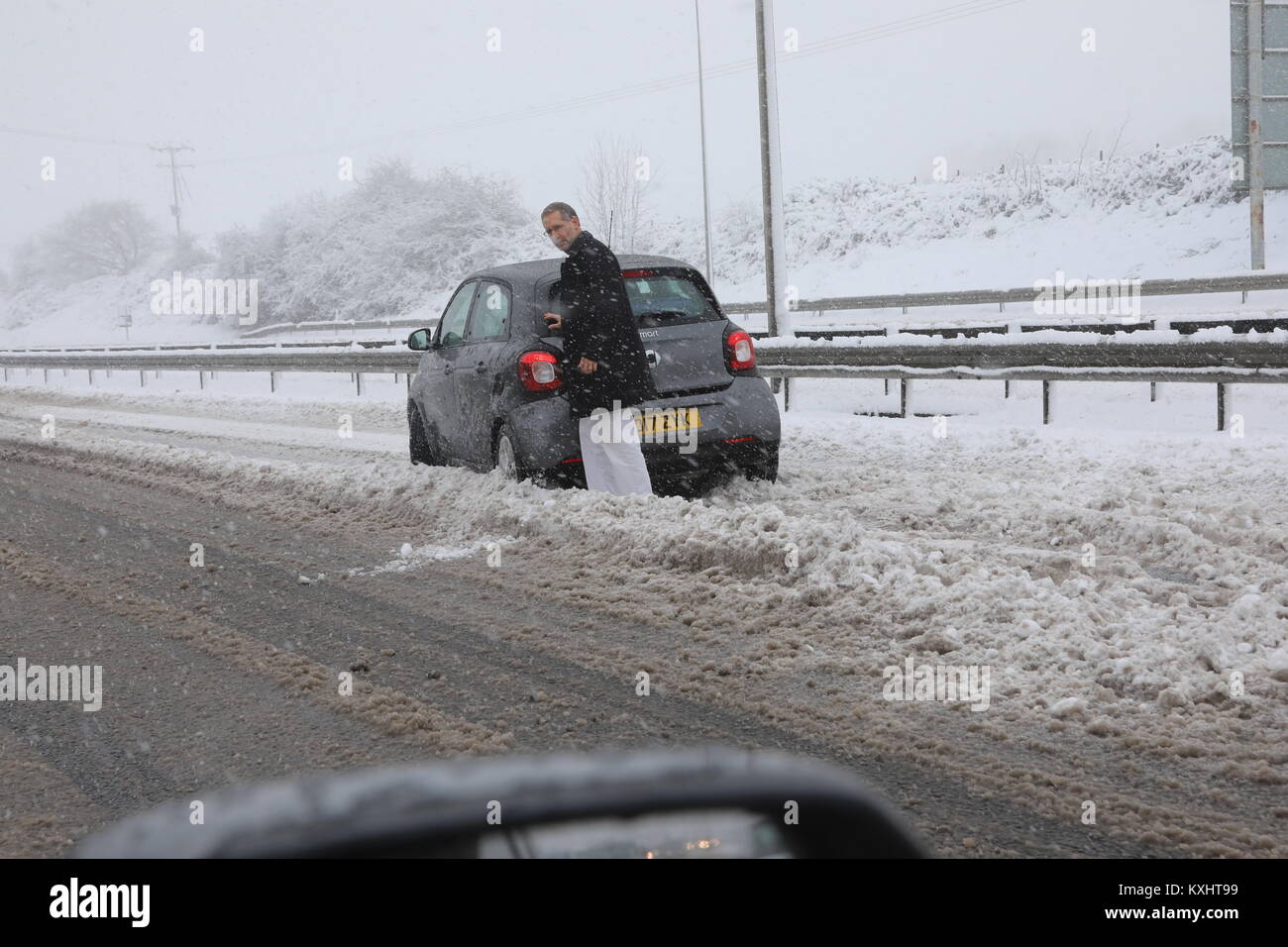A vehicle has a spot of difficulty in the snow on the M25 motorway ...