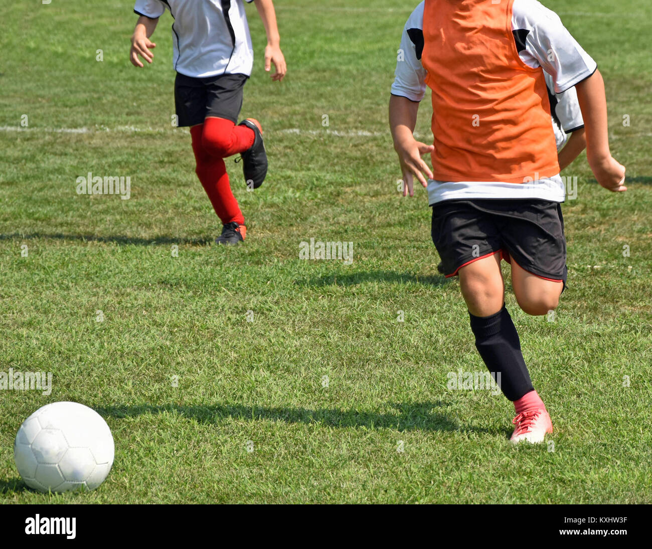 Kids are playing soccer outdoor Stock Photo - Alamy