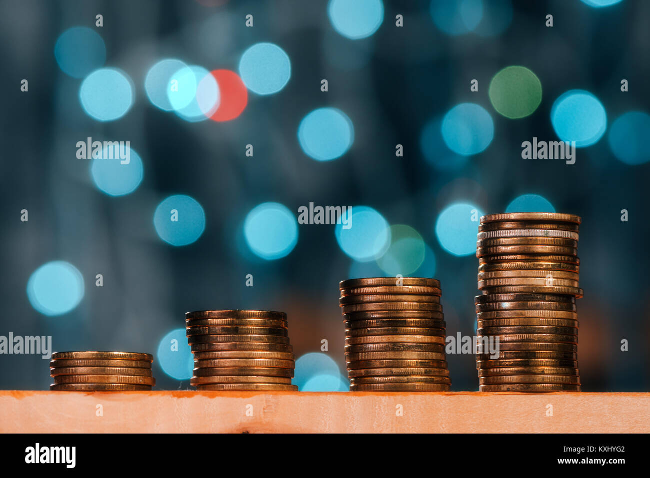 Money savings concept with coin stack and increasing columns of metal ...