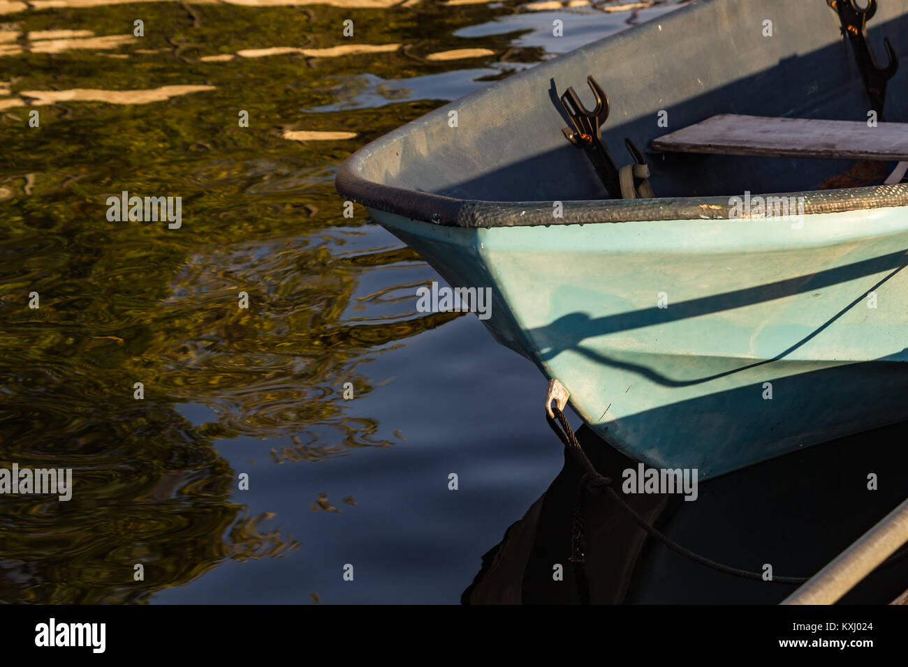 little blue dingy on evening water Stock Photo - Alamy