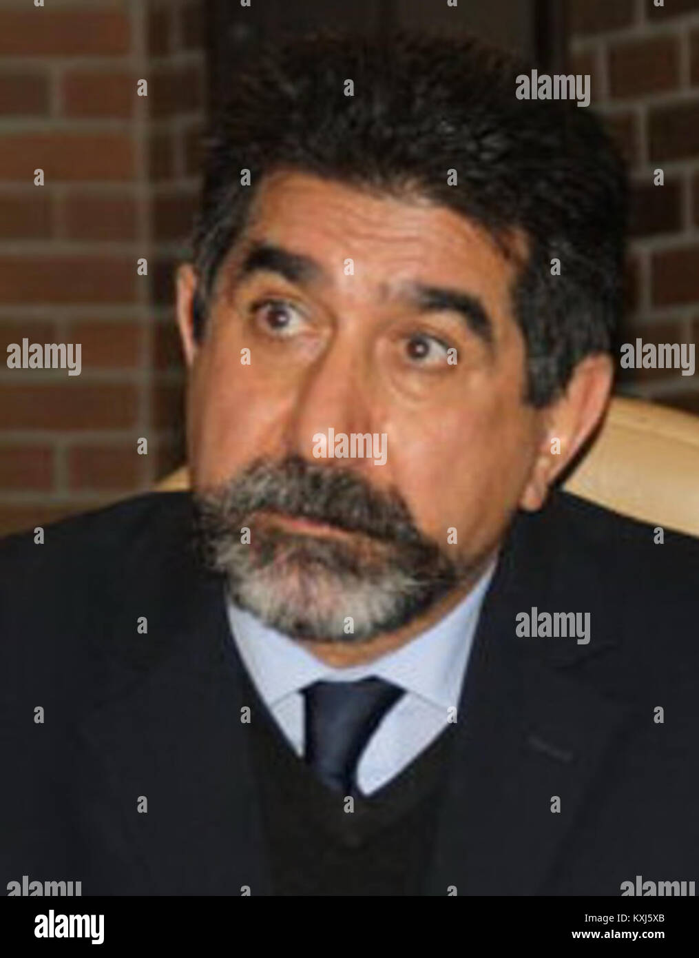 This image shows an individual named Azizi speaking in Toronto. The ...