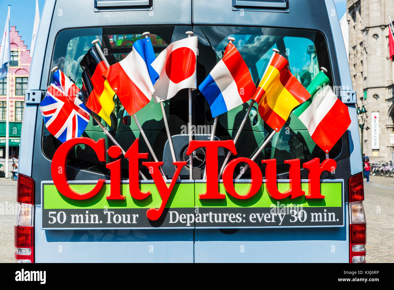 Bruges, Belgium, - August 31, 2017: Tour bus full of flags of various ...